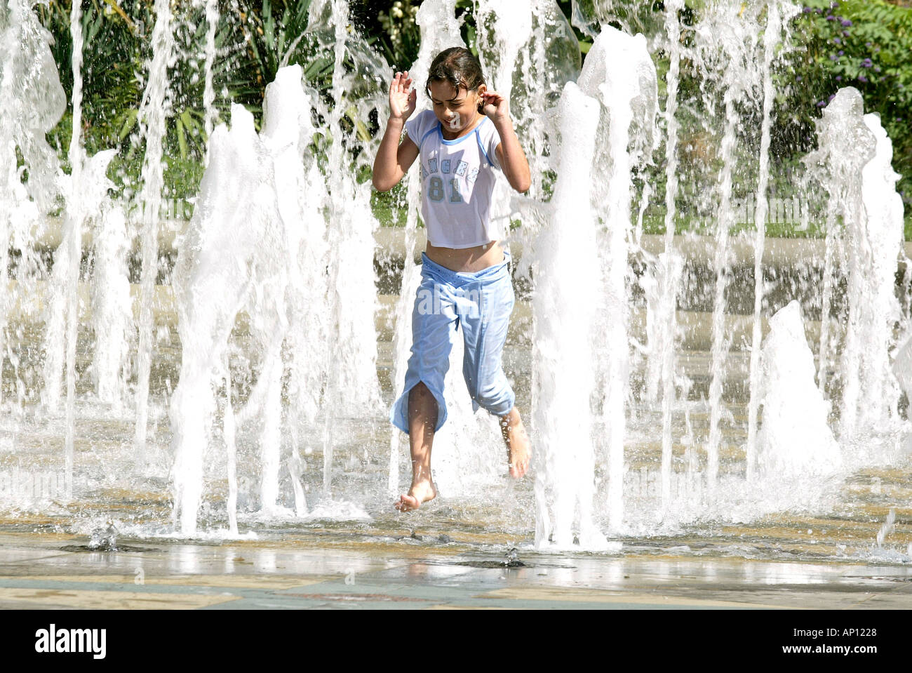 Girl running water fountain hi-res stock photography and images - Alamy