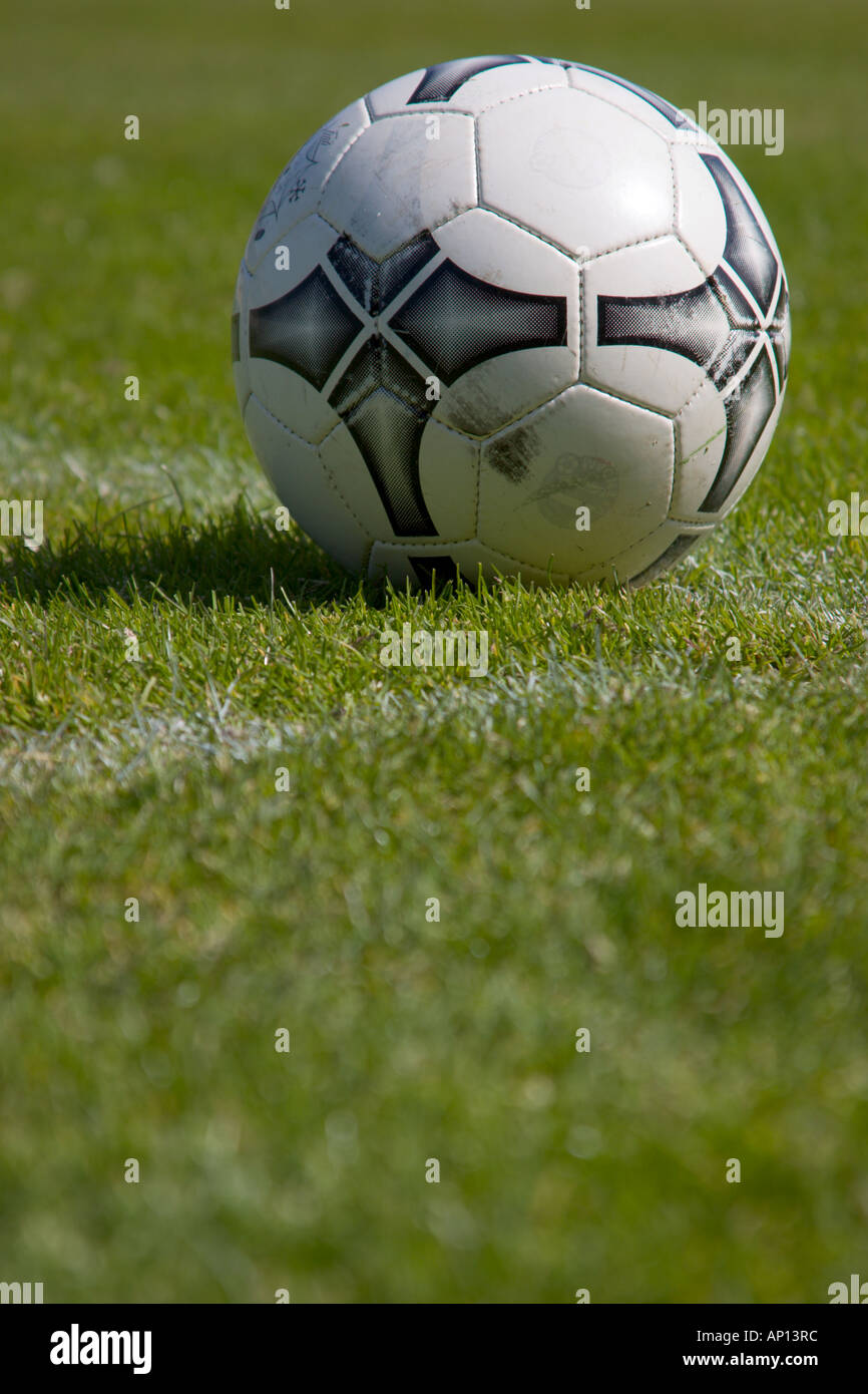 Soccer ball on soccer field with narrow band of sharpness / depth of ...