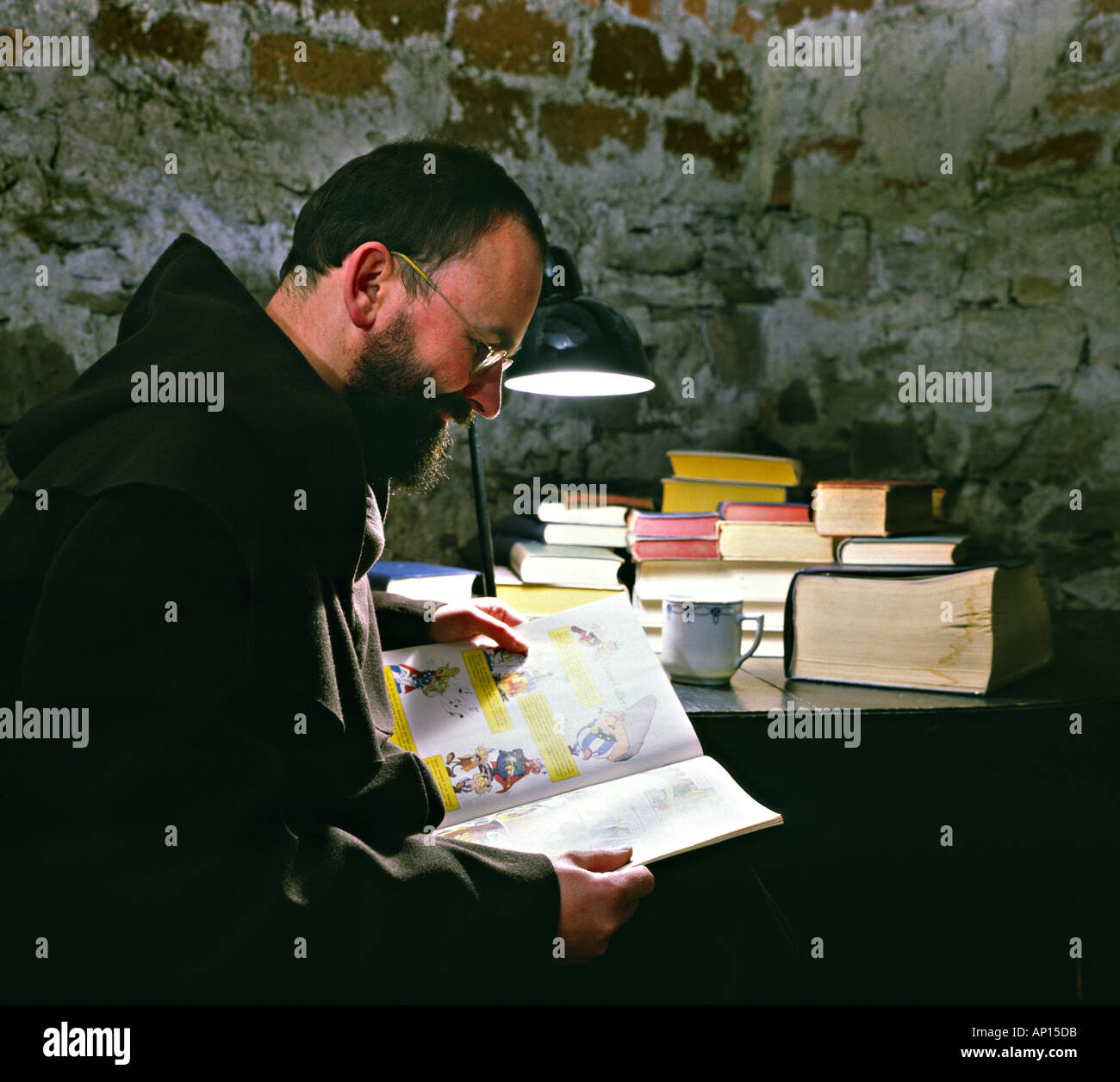 monk reading comics Stock Photo - Alamy