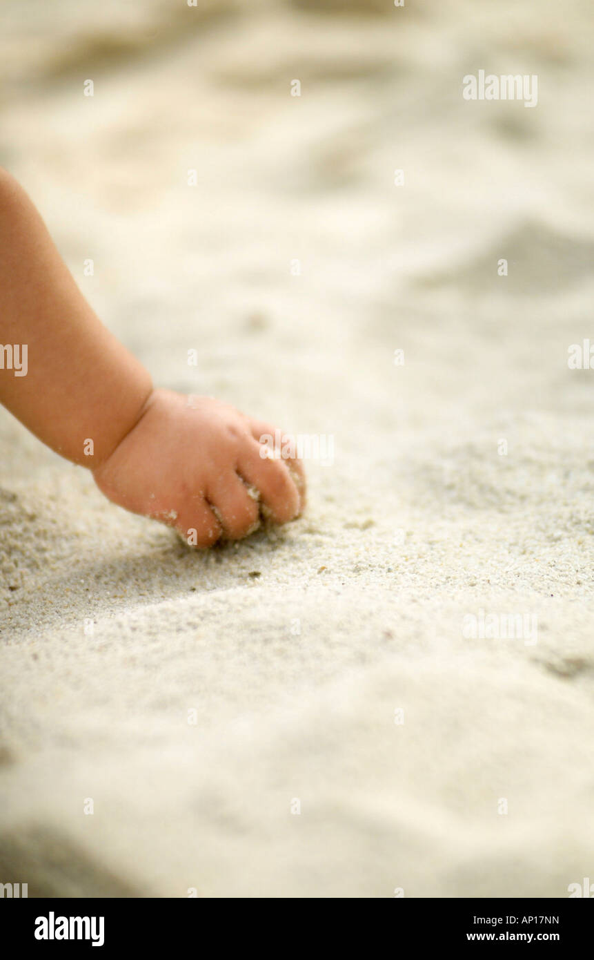 Child's hand playing with sand Stock Photo - Alamy