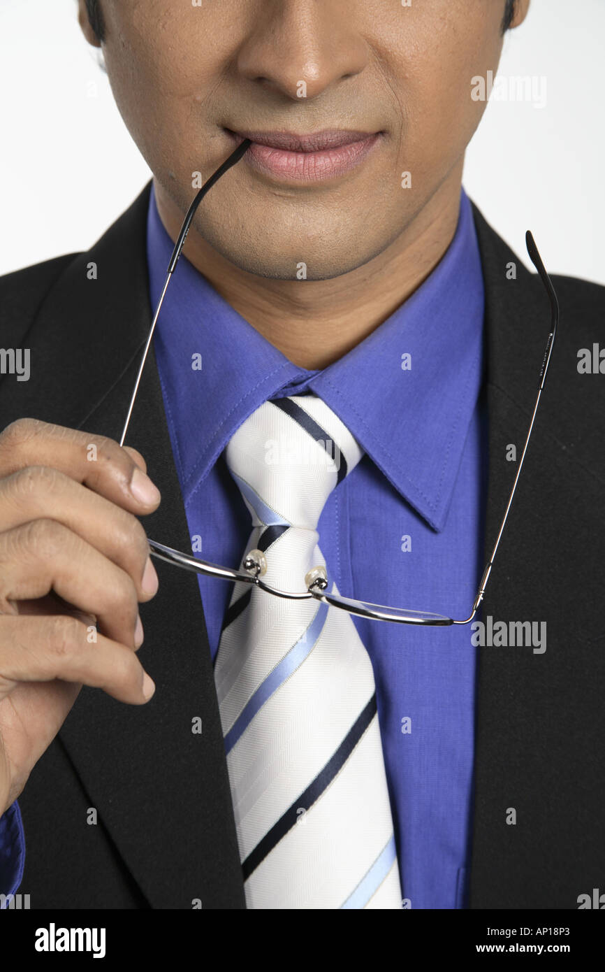 ANG200023 Executive holding spectacles glasses in one hand Stock Photo ...