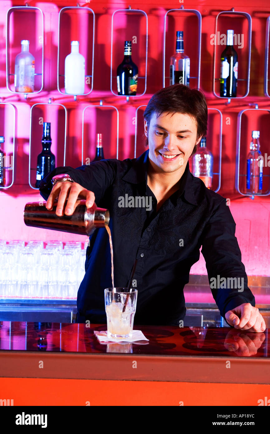 Bartender pouring drink behind bar Stock Photo - Alamy
