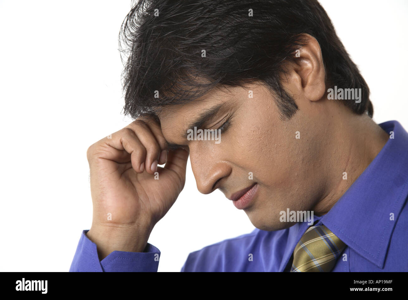 ANG200141 Executive touching his forehead with hand with closed eyes ...