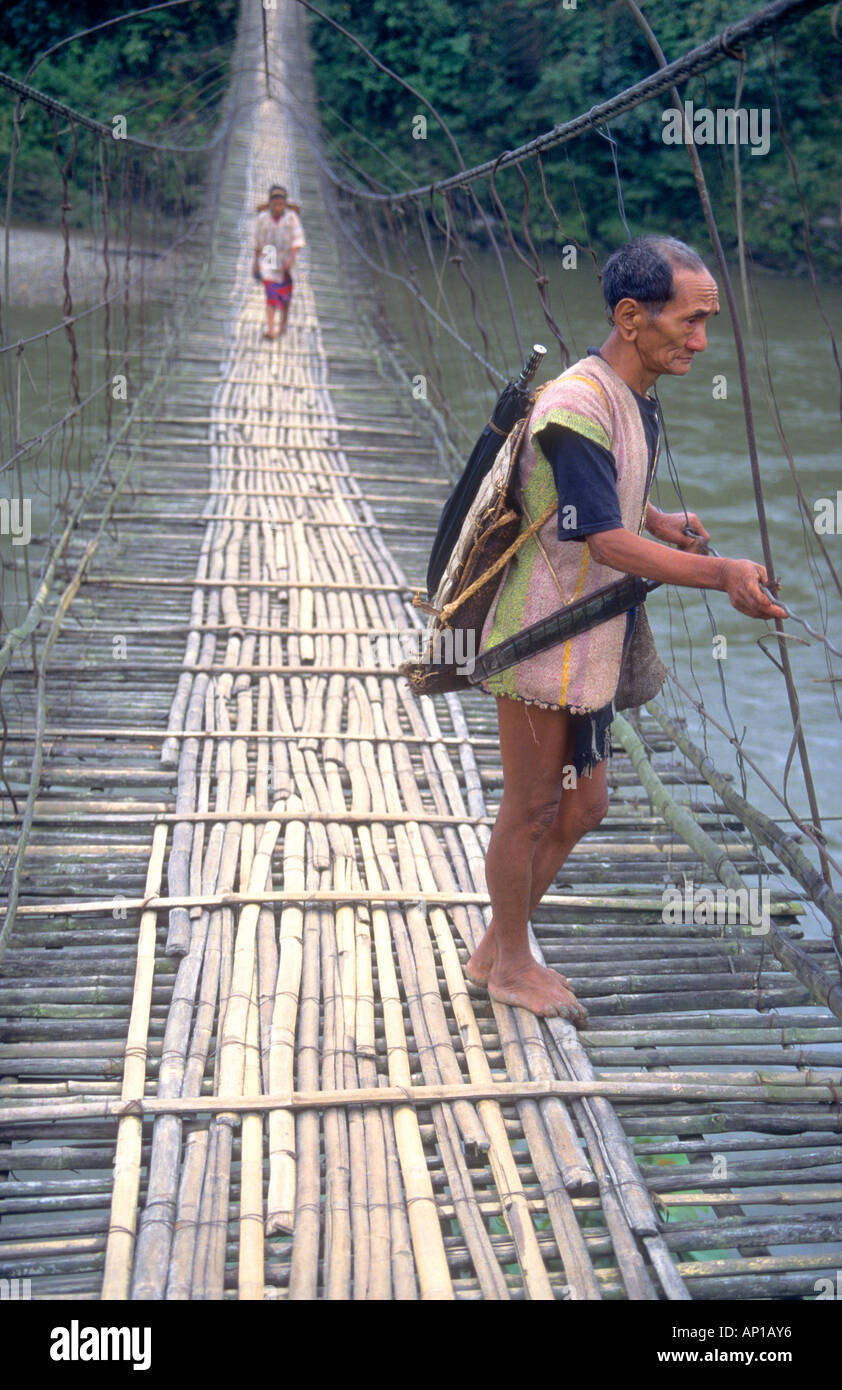 Apatani tribesman with umbrella on typical flimsy bamboo bridge in ...