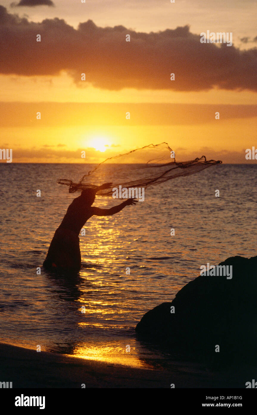 A fisherman throwing out a net at sunset, Fiji, Asia Stock Photo - Alamy