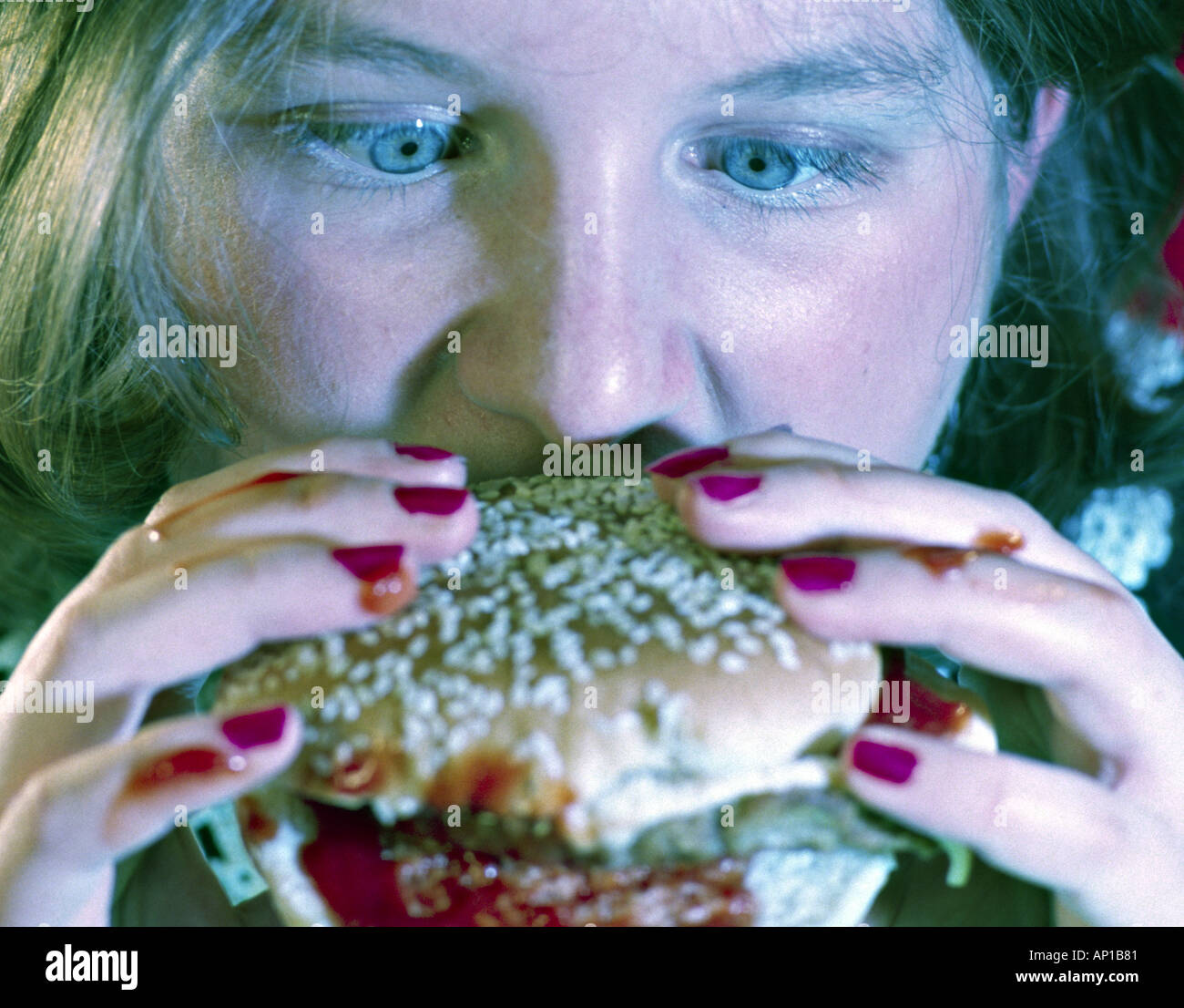 Woman biting big fast food hi-res stock photography and images - Alamy