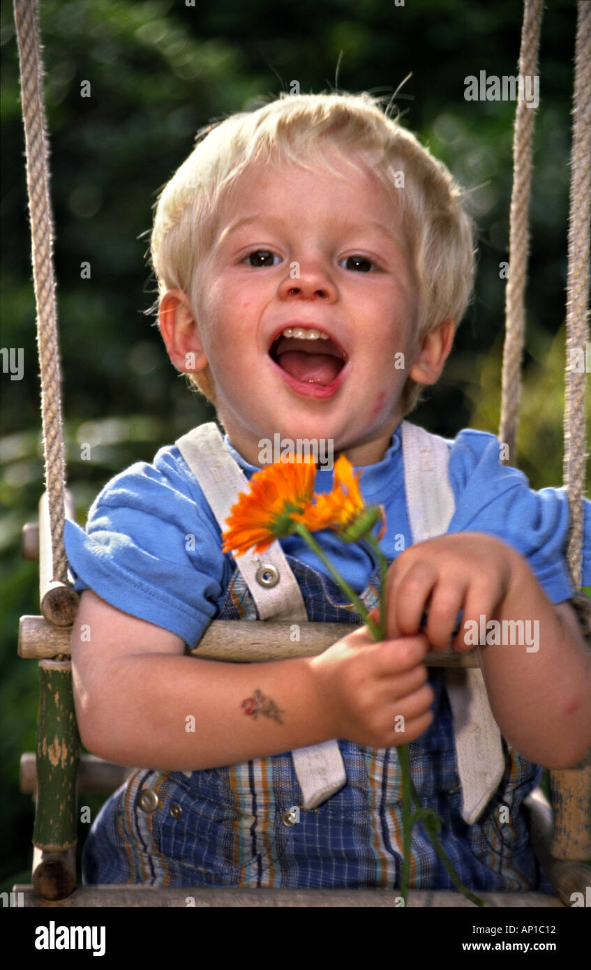 small child swinging in garden Stock Photo - Alamy