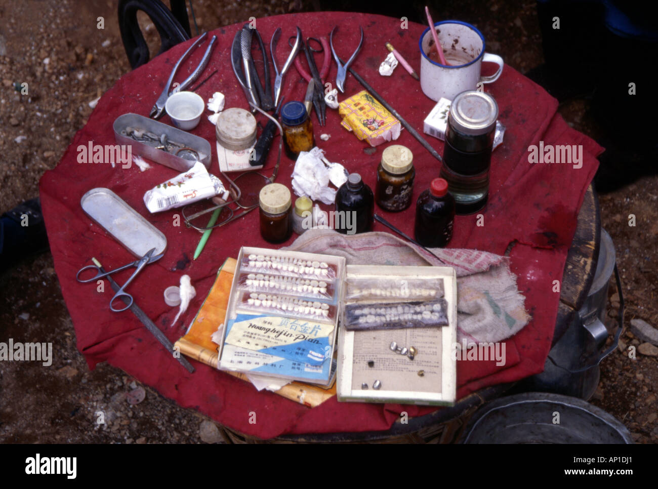 Street dentists work table with his tools and selection of false teeth ...