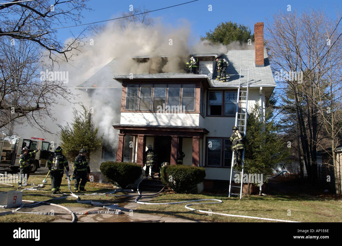 Firefighters fighting a fire House fire Stock Photo - Alamy