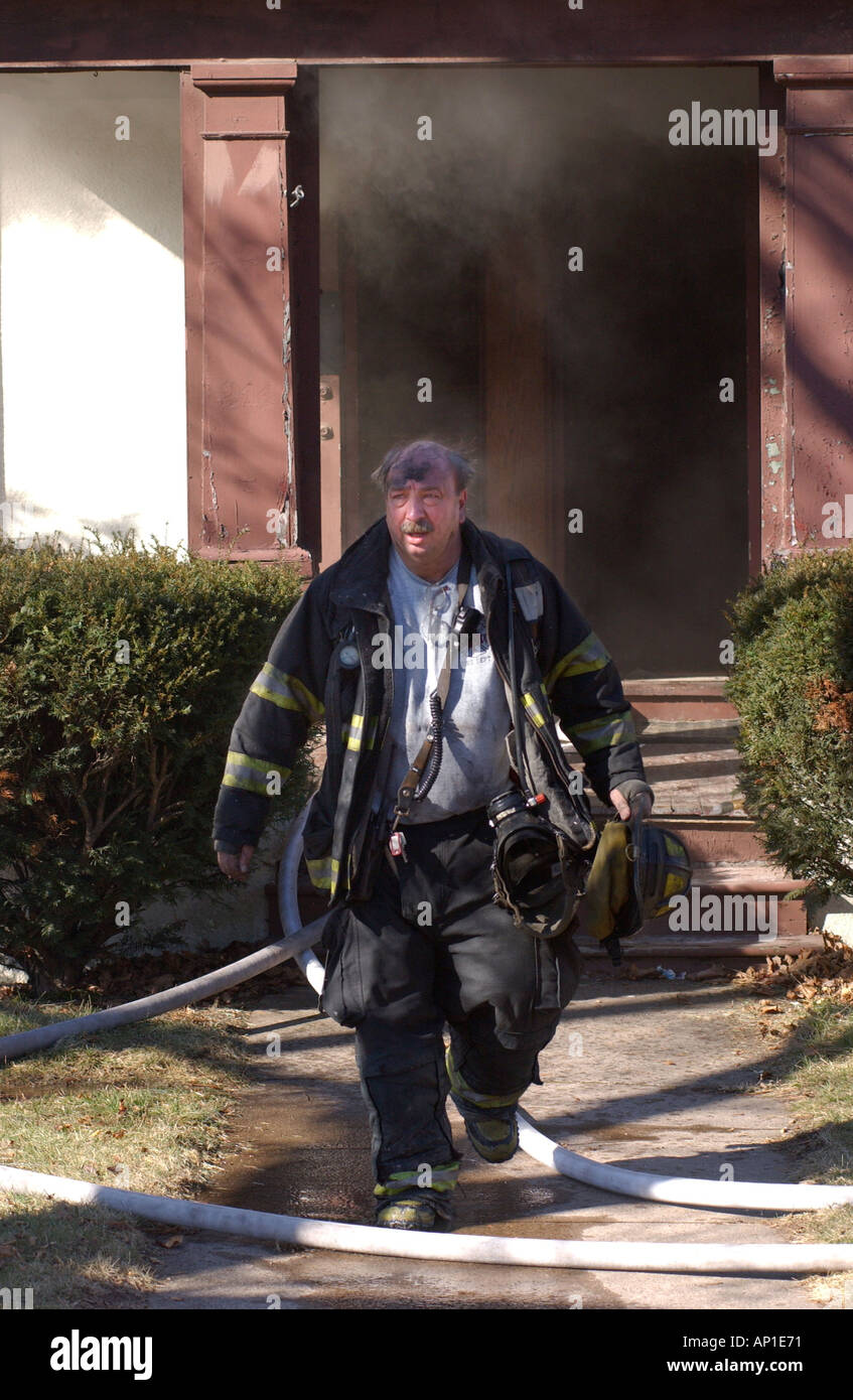 Firefighters fighting a fire House fire Stock Photo - Alamy
