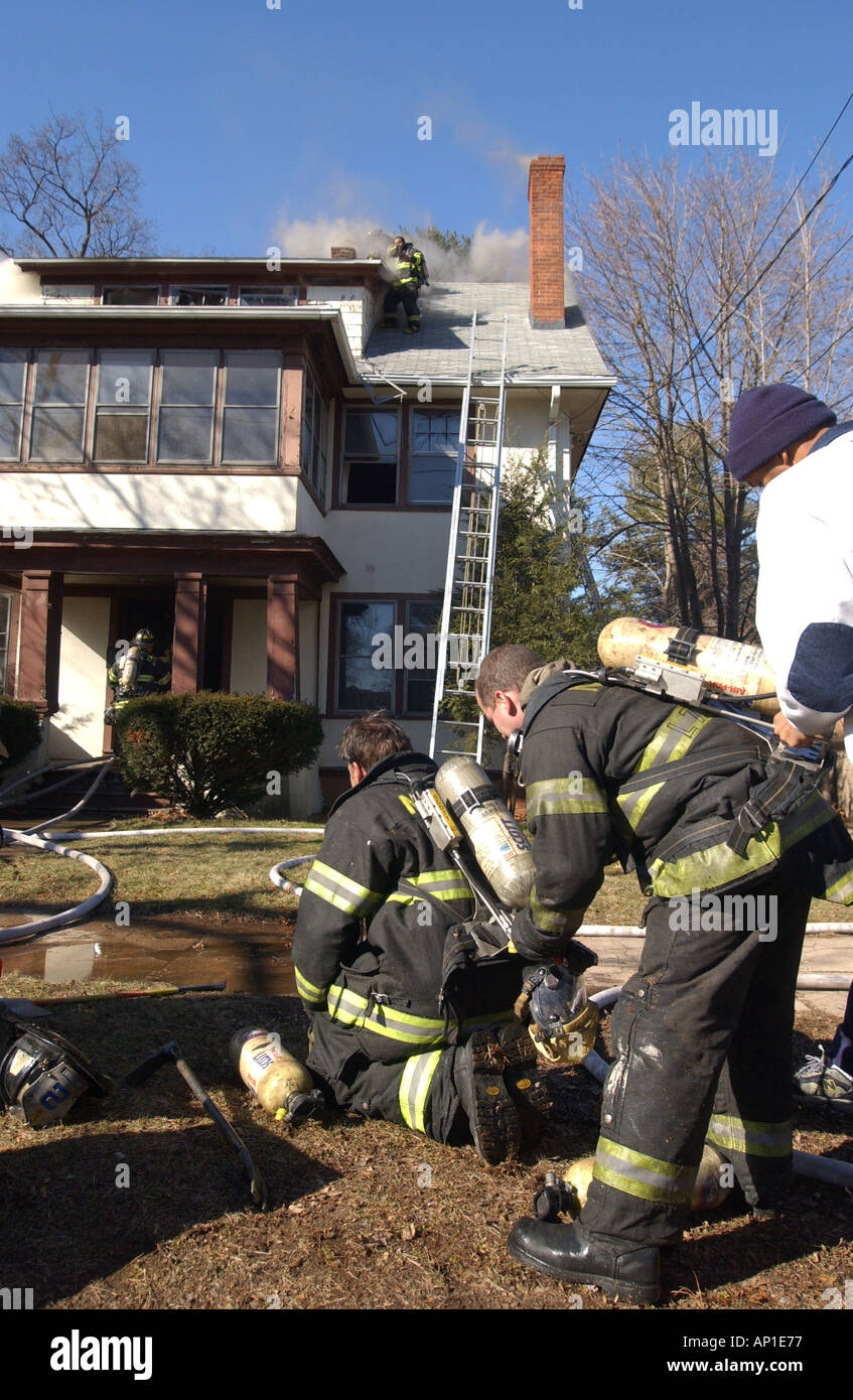 Firefighters fighting a fire House fire Stock Photo - Alamy