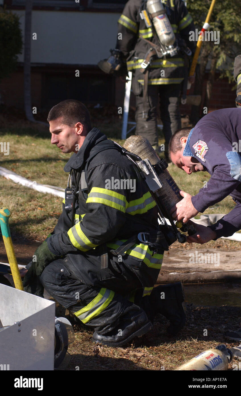 Firefighters fighting a fire House fire Stock Photo - Alamy