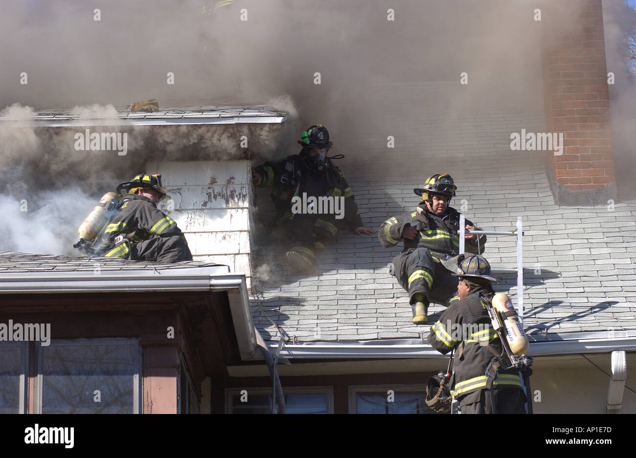 Firefighters fighting a fire House fire Stock Photo - Alamy