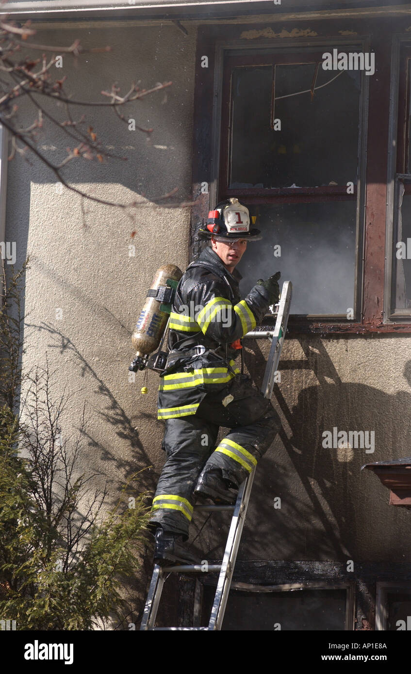 Firefighters fighting a fire House fire Stock Photo - Alamy