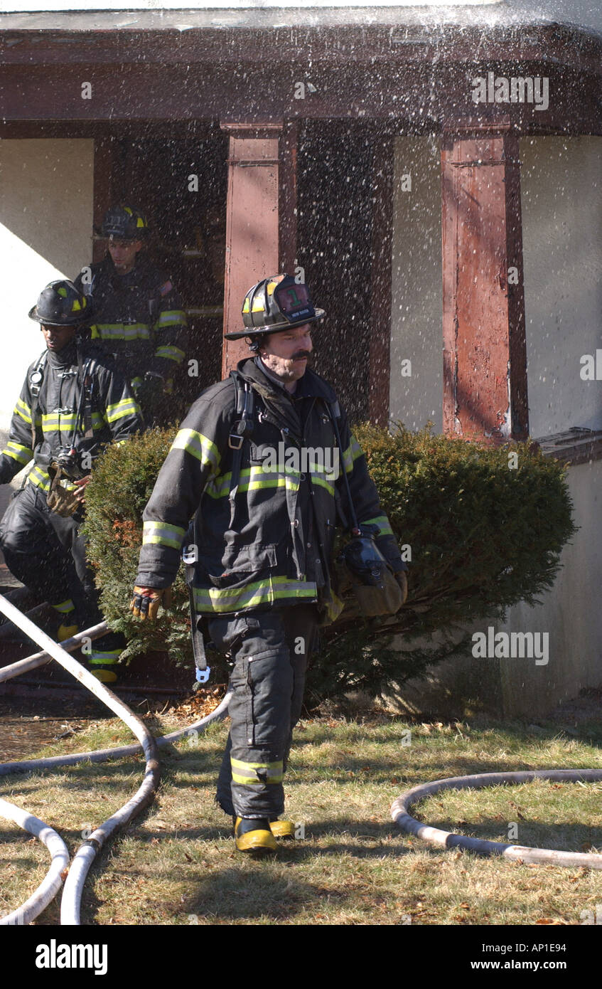 Firefighters fighting a fire House fire Stock Photo - Alamy