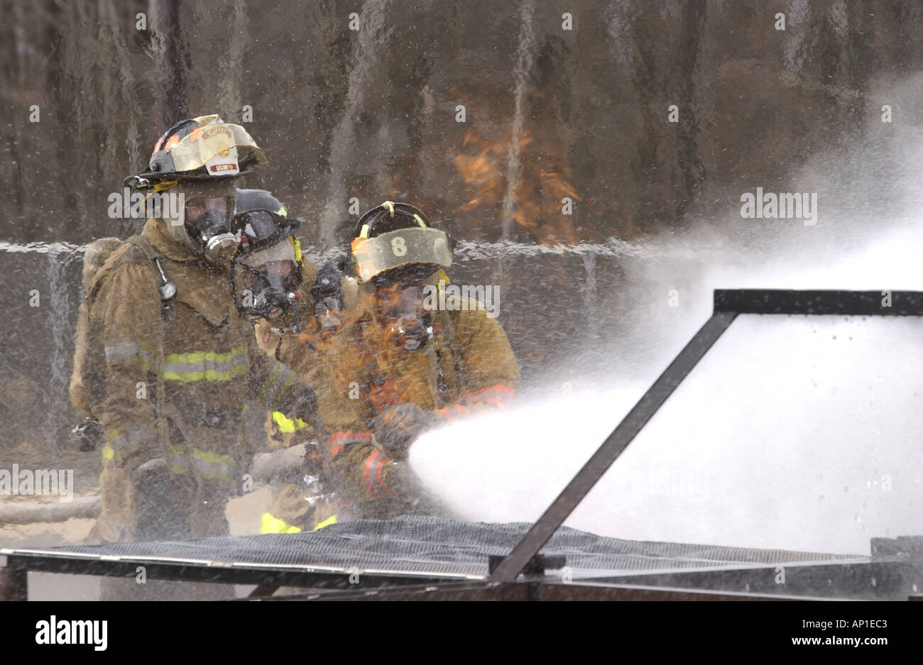 Firefighters training at school spray Stock Photo - Alamy