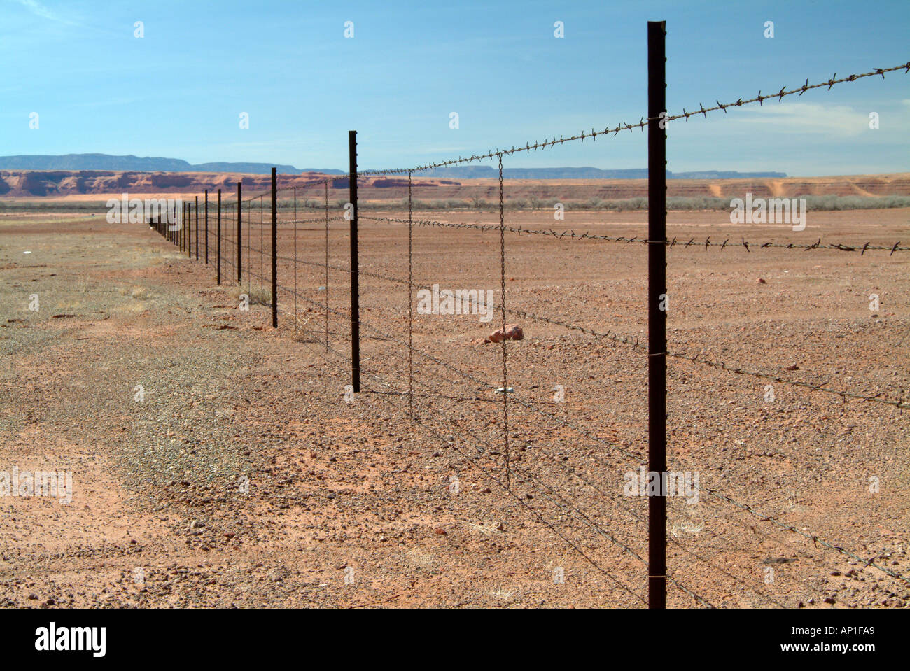 Barbed wire fence in desert Stock Photo - Alamy