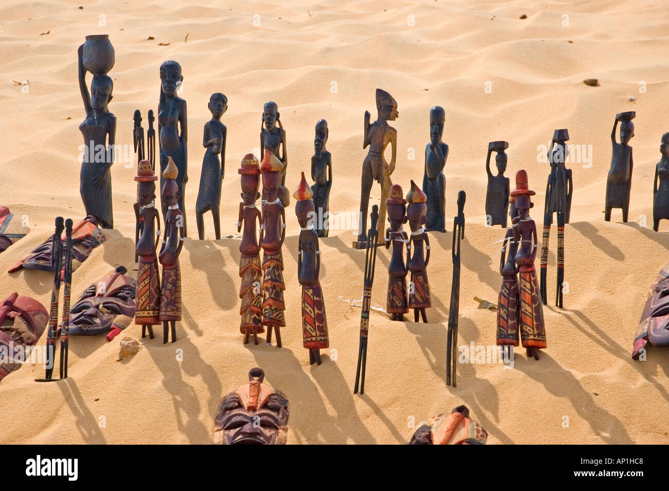 Hand carved Nubian wooden stick figure dolls stuck in the sand, for ...