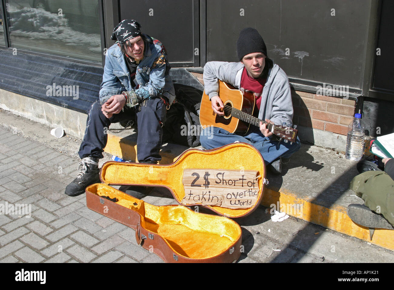 street kids busking for change with comedic sign Stock Photo - Alamy