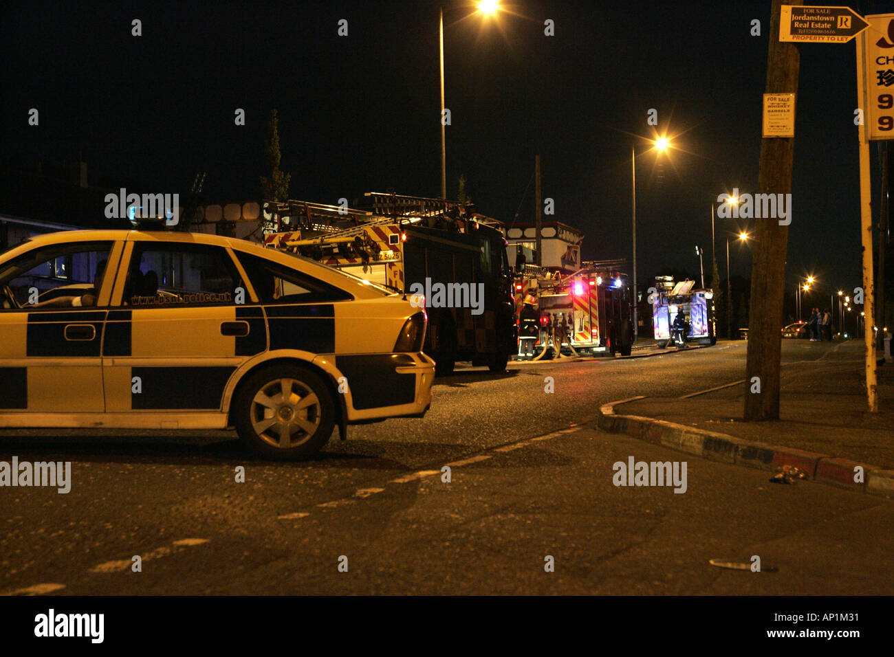 Police squad car and fire service vehicles attend fire at Cloughfern ...