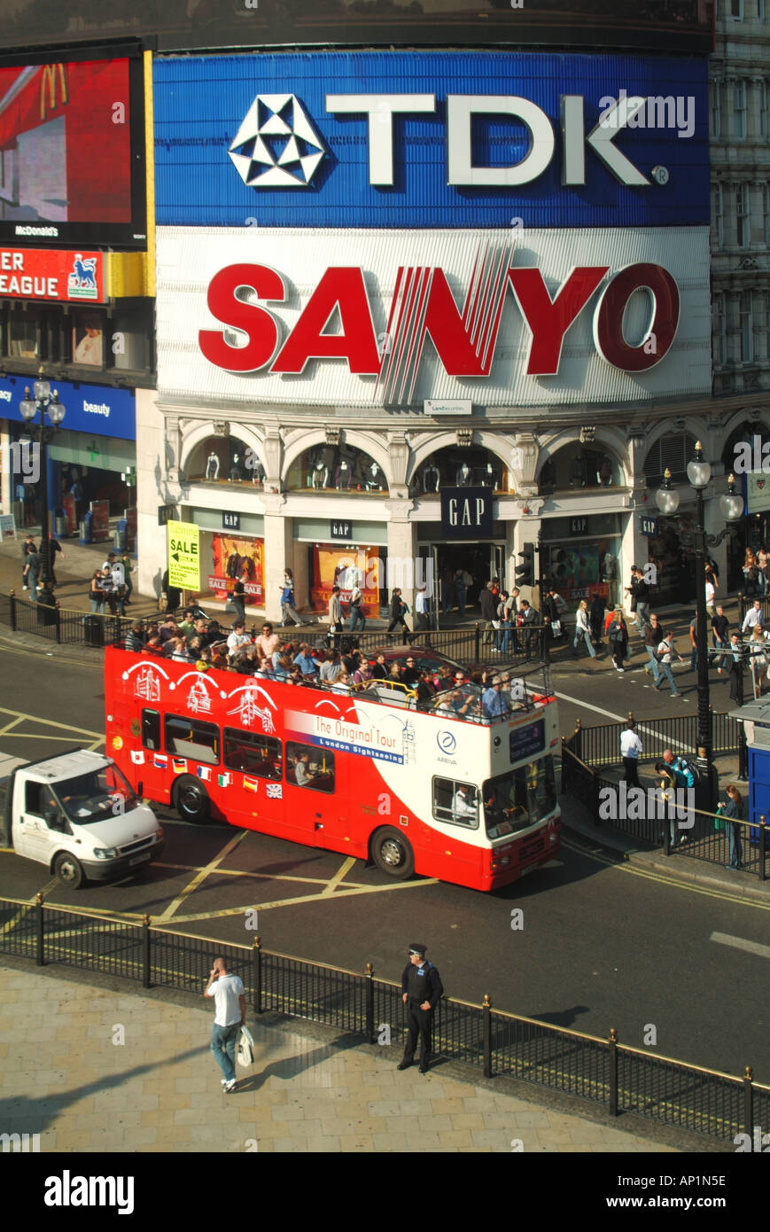Semi Aerial view open top tour bus at Piccadilly Circus passing ...