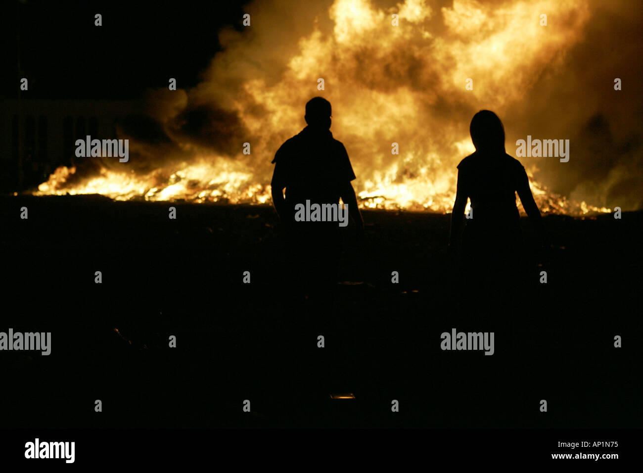 couple walks past 11th night bonfire in Monkstown Stock Photo - Alamy