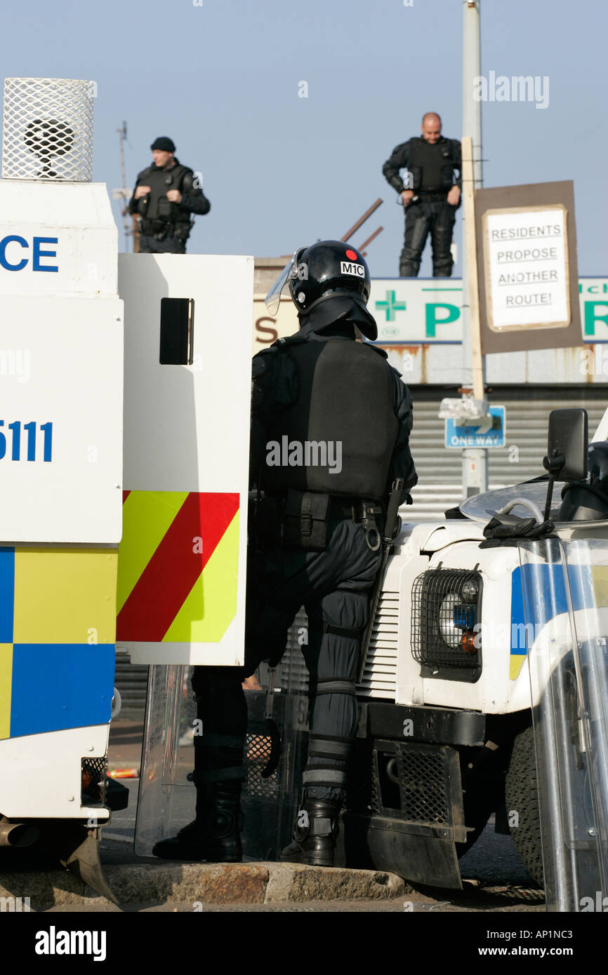 PSNI officers in protective riot gear at landrovers and snipers on ...