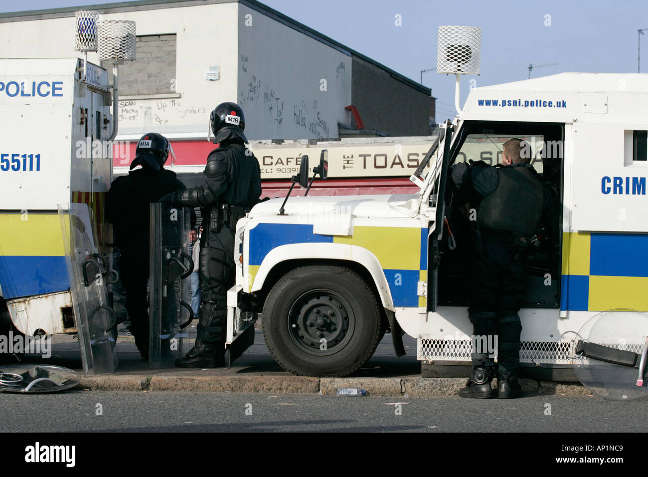 PSNI officers in protective riot gear at landrovers on crumlin road at ...