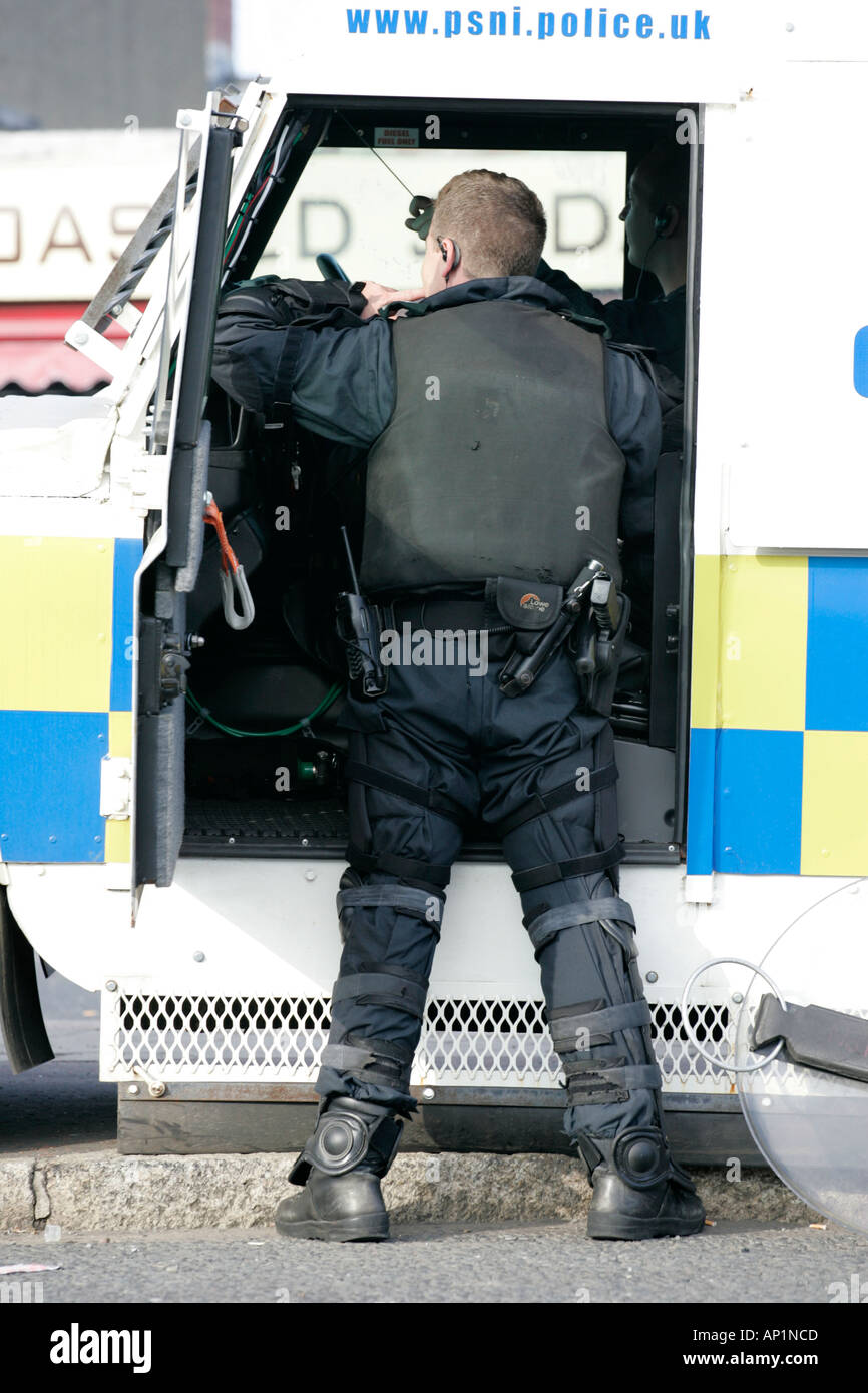PSNI officer puts on protective riot gear on crumlin road at ardoyne ...