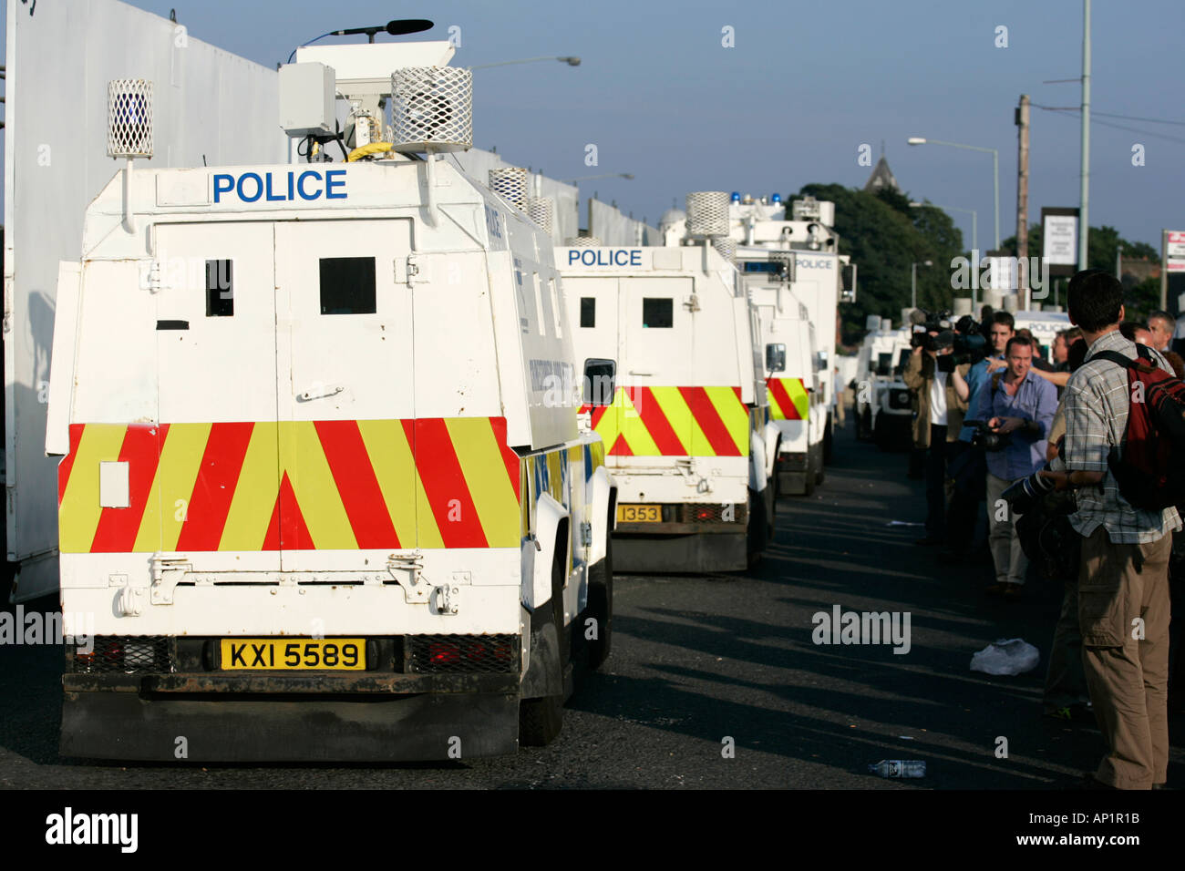 Line of PSNI land rovers and world media on crumlin road at ardoyne ...