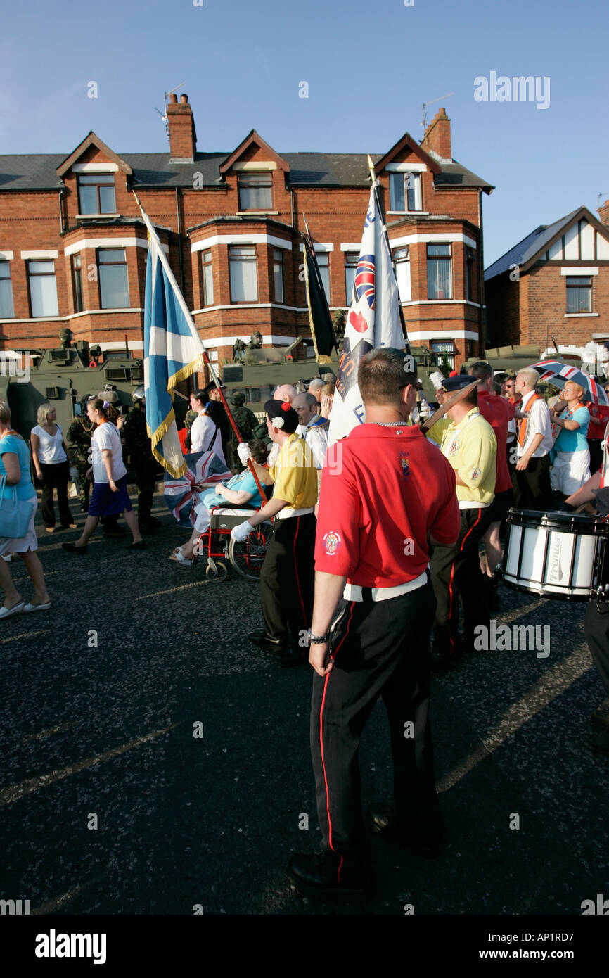 loyalist band with flags marching on crumlin road at ardoyne shops ...
