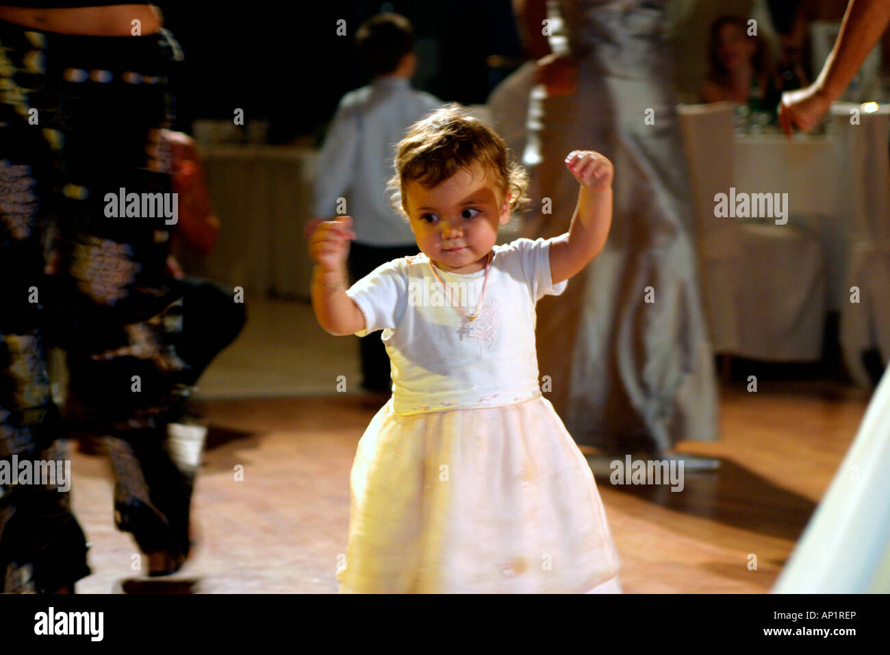 greece a little girl dancing at a traditional greek wedding celebration ...