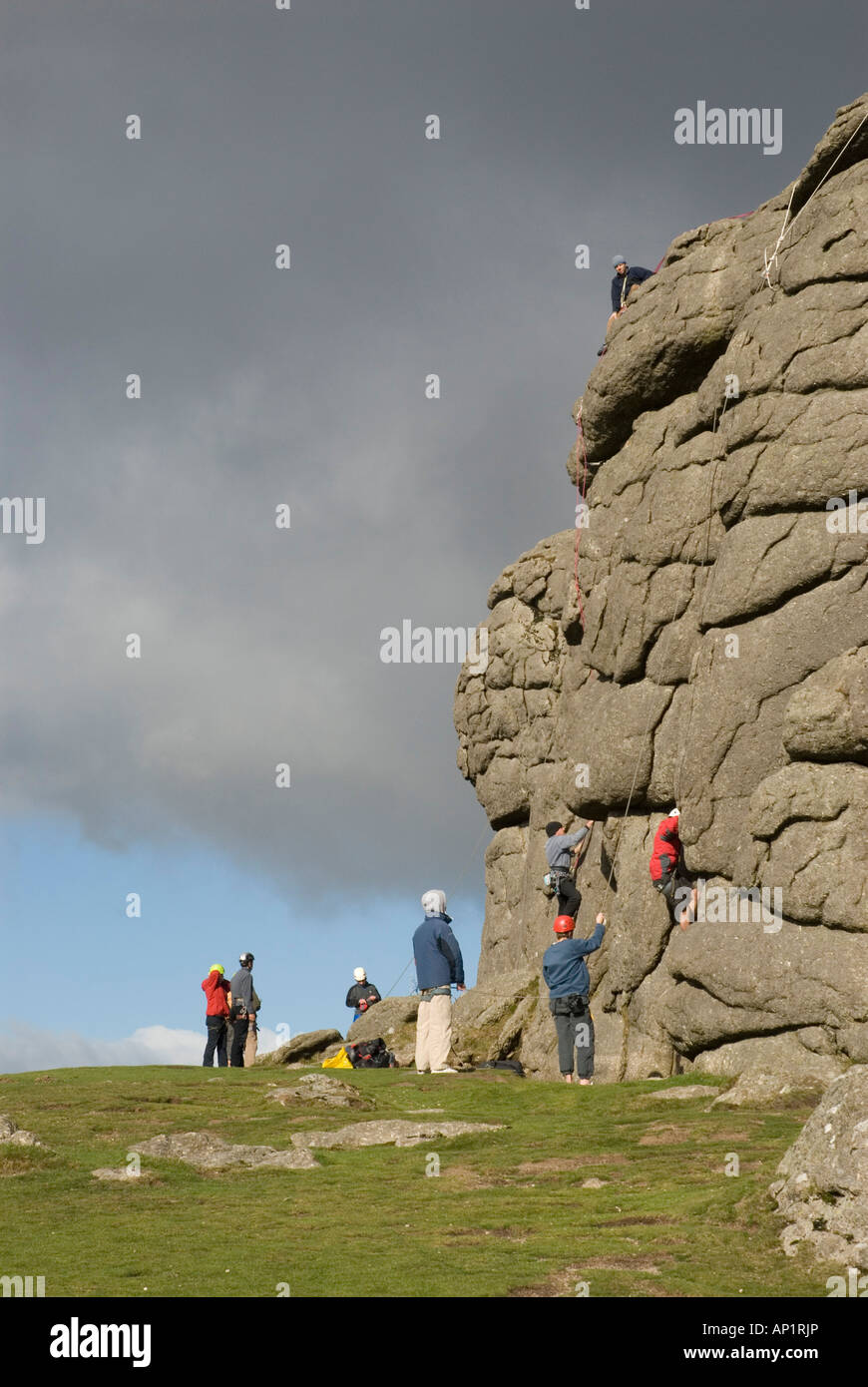 Youngsters learning to climb on granite haytor rocks hi-res stock ...