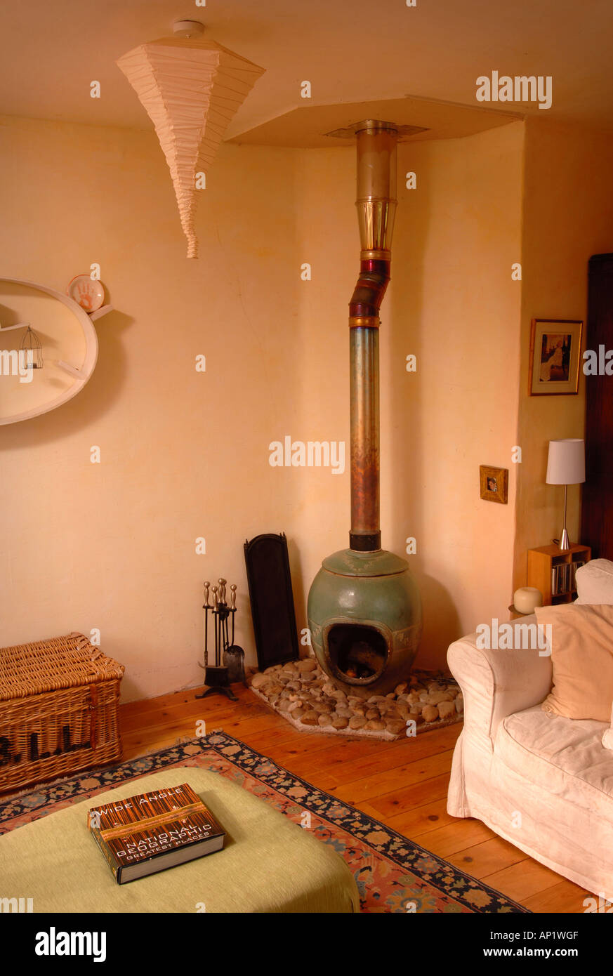 A WOOD BURNER IN THE LIVING ROOM OF A HOUSE BUILT WITH STRAW BALE WALLS ...