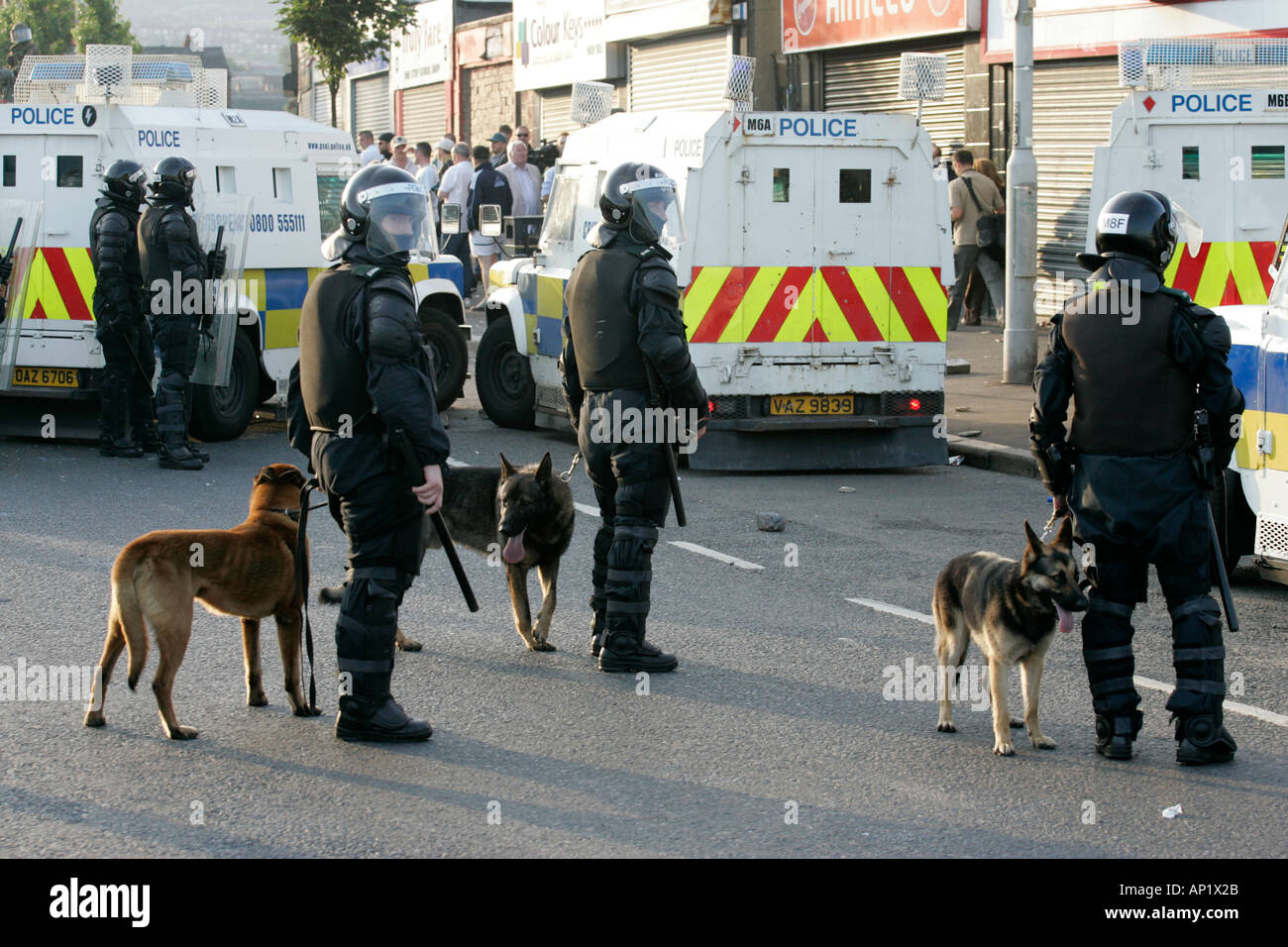 PSNI dog handlers in riot gear and dogs on crumlin road at ardoyne shops belfast 12th July Stock ...