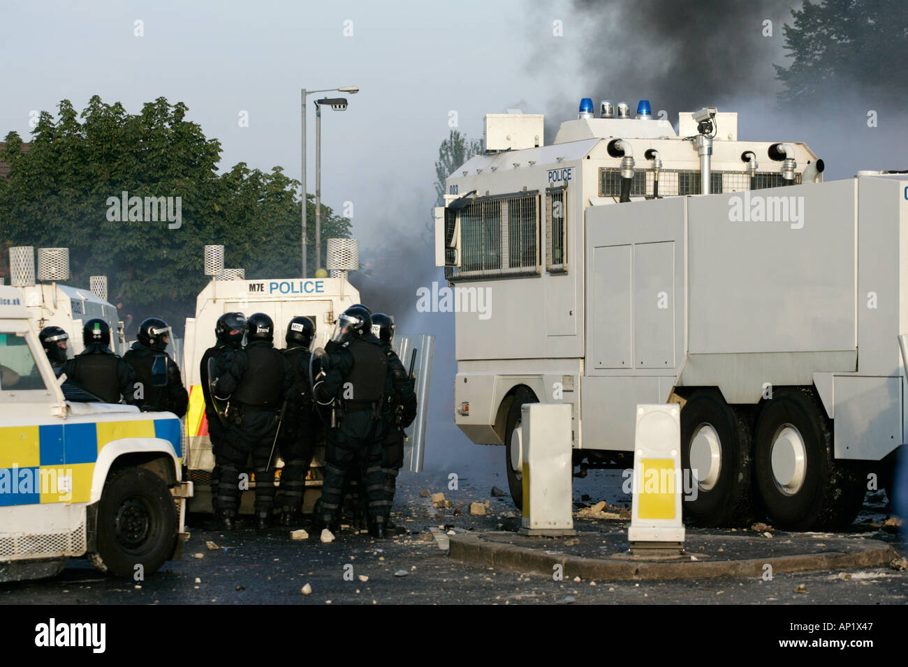 PSNI riot officers behind armoured land rover and water cannon on ...