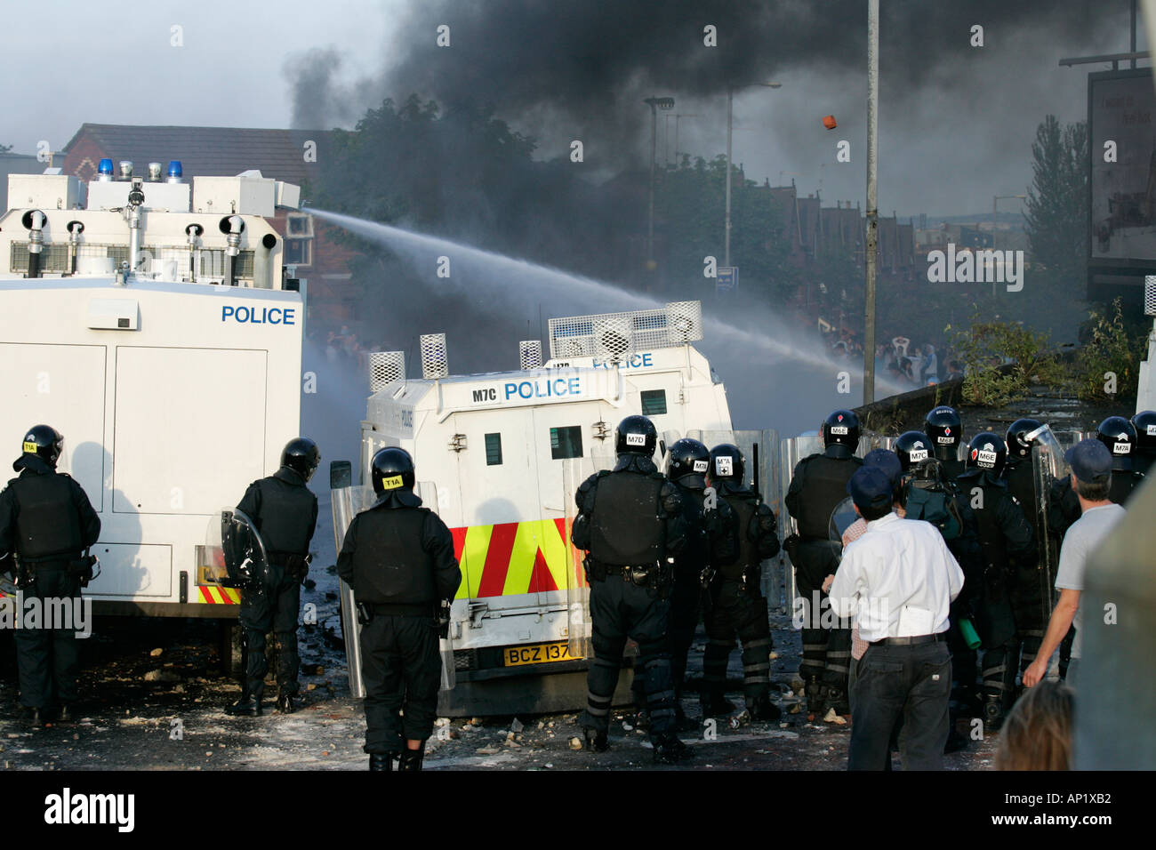 PSNI riot officers behind armoured land rover and water cannon on ...