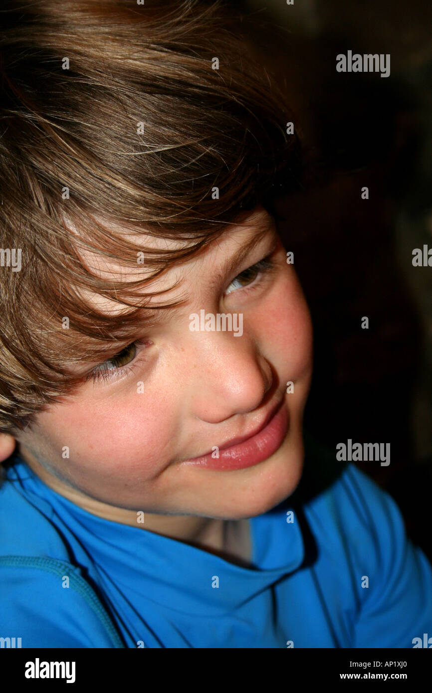 Young boy looking pleased with himself, with a comfortable beautiful ...