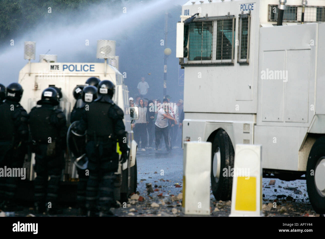PSNI riot police behind armoured land rover and water canon face on ...
