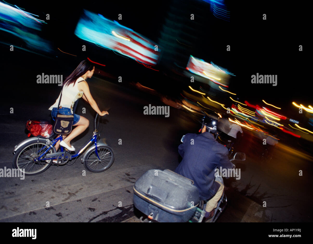 Girl riding bike on street at night china hi-res stock photography and ...
