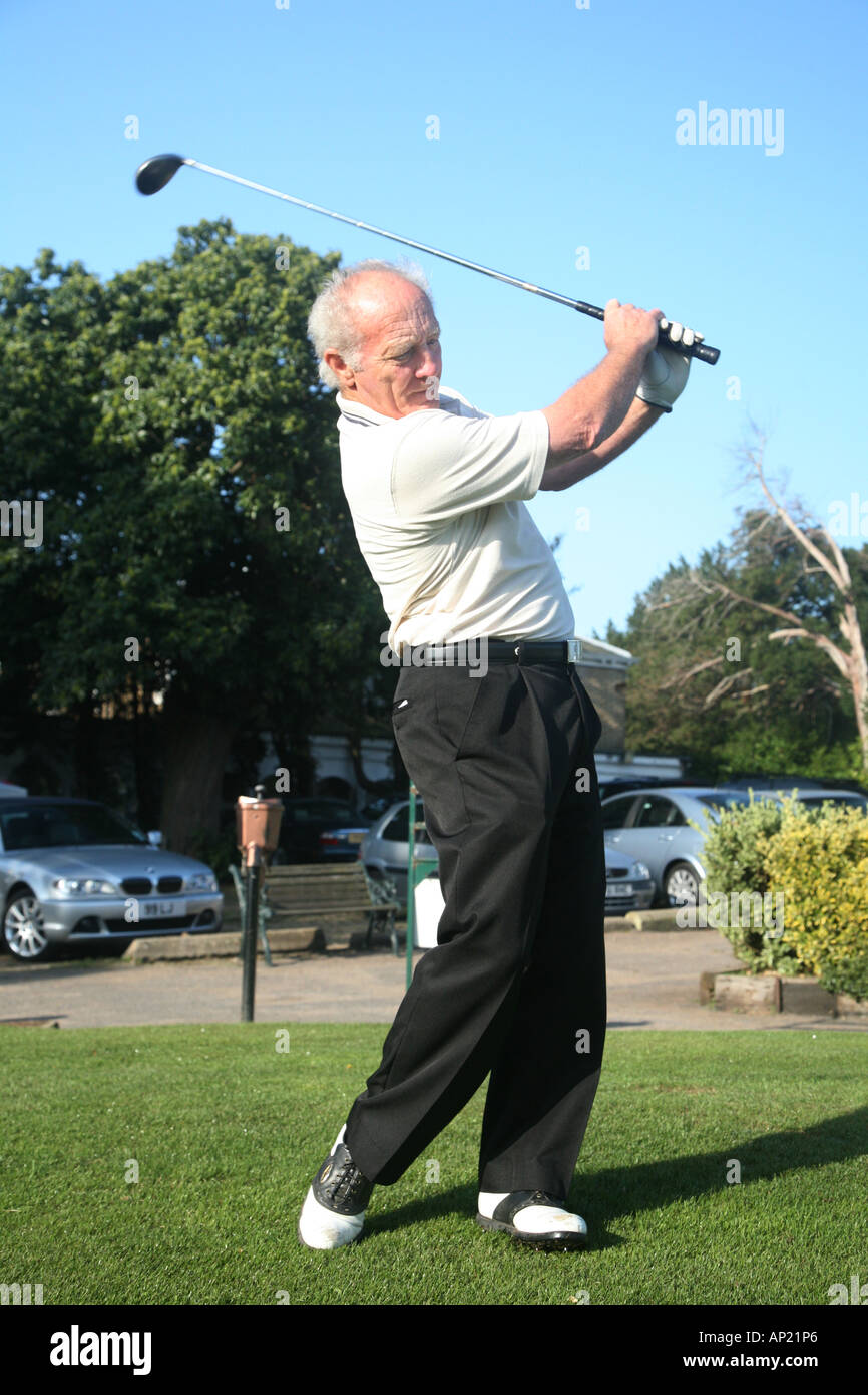 Man teeing off Stock Photo - Alamy