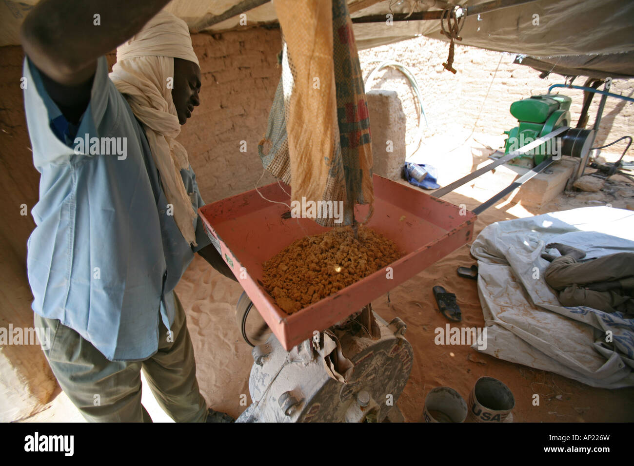 Sudanese refugee turns corn and grain into flour in refugee camp in ...
