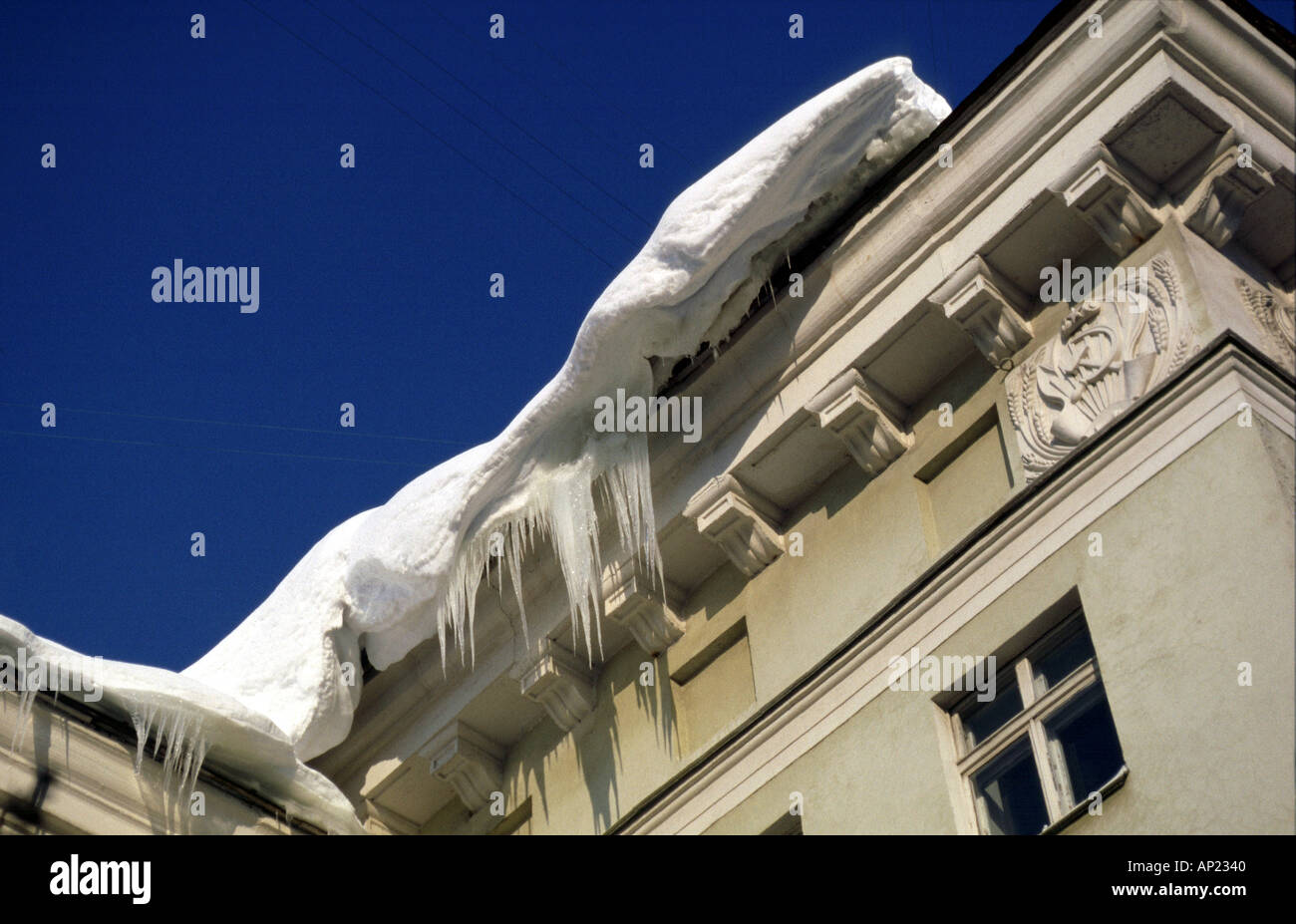 Snow hanging over roof Murmansk Russia Stock Photo - Alamy