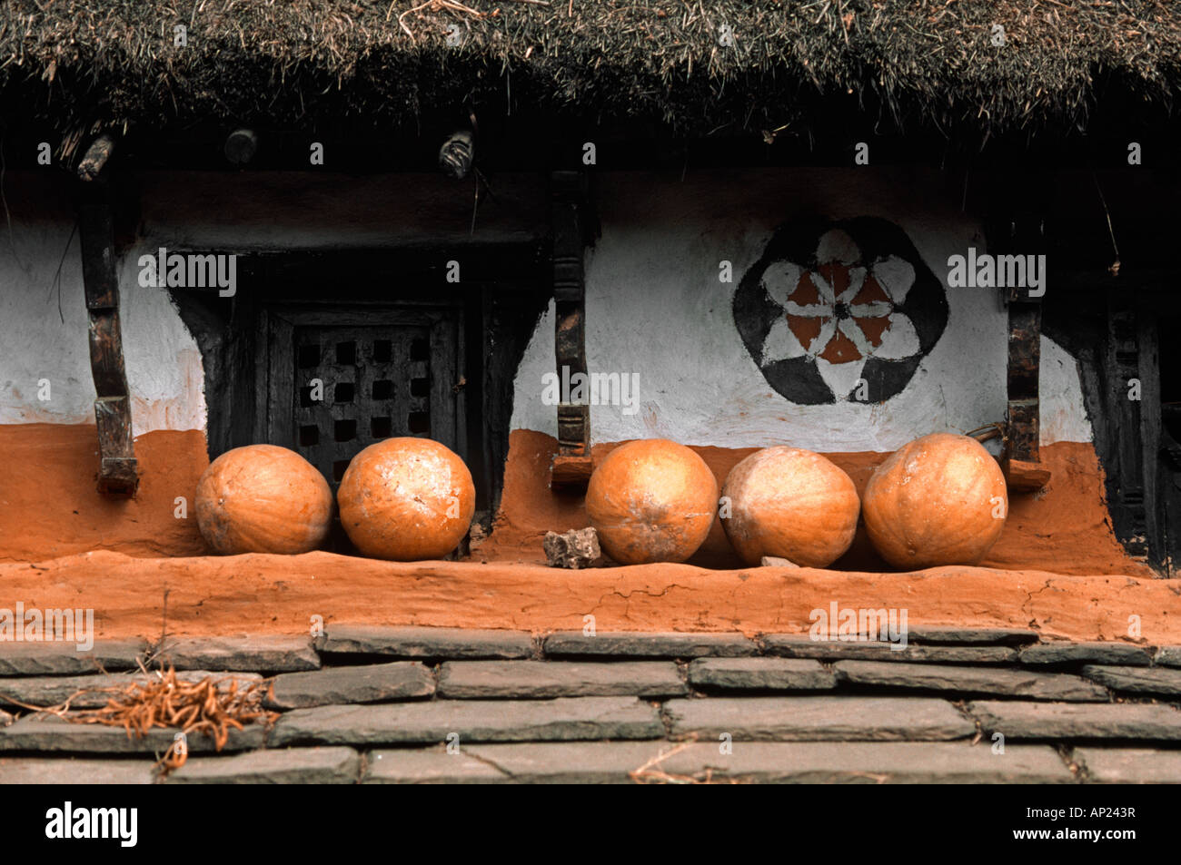 PUMPKINS are stored on the balcony of a PAINTED NEPALESE FARM HOUSE ...