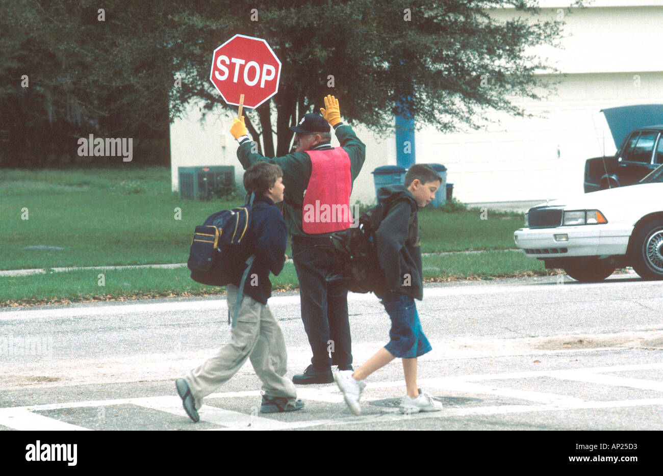 Crossing guard and students near elementary school Stock Photo - Alamy