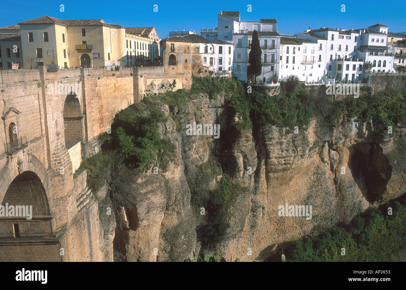 The gorge in Ronda Spain with buildings on the edge and a view of the ...