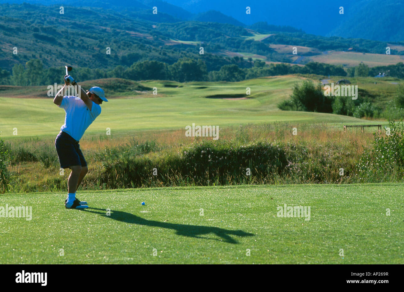 Golfer teeing off Haymaker golf course Steamboat Springs Colorado USA ...