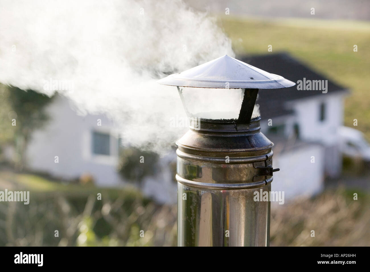 A household chimney emmiting smoke Stock Photo - Alamy