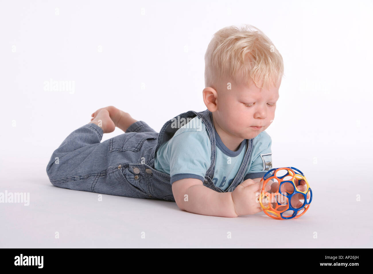 Little boy looking at a ball Stock Photo - Alamy