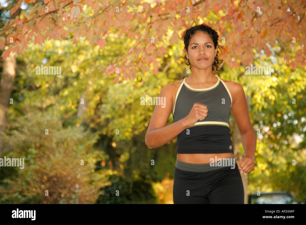 Focused young woman jogging outdoors hi-res stock photography and ...